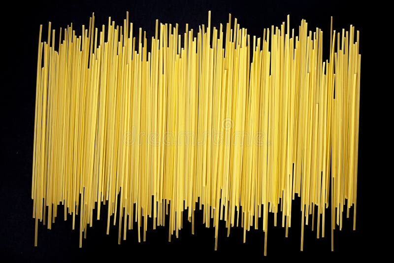 Raw Flat Spaghetti on Black Background Stock Photo - Image of ...