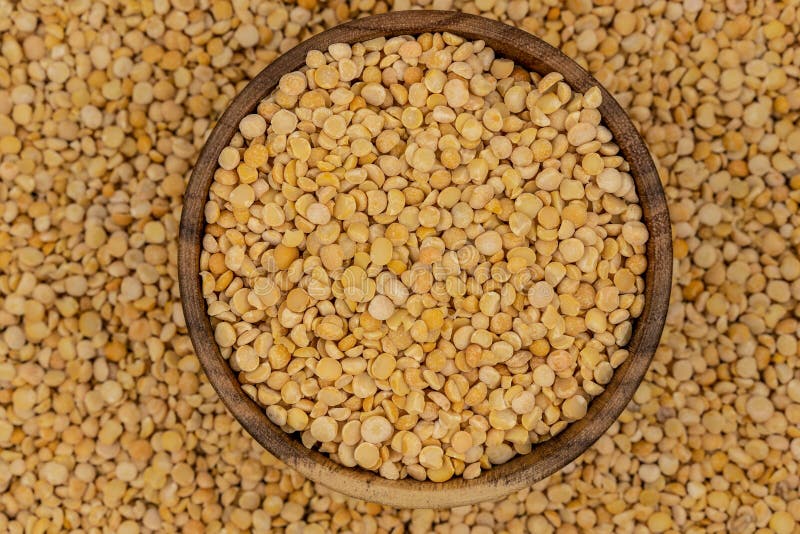 Raw Yellow Split Peas in a Wooden Plate on a Background of Pea Texture ...