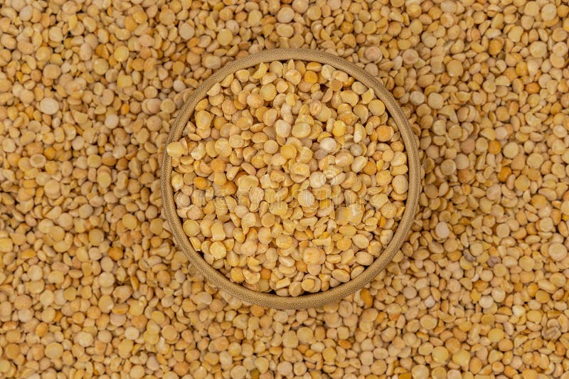 Raw Yellow Split Peas in a Wooden Plate on a Background of Pea Texture ...