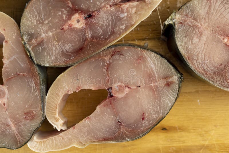 Raw Yellow-tailed Fish during Cutting for Cooking Stock Photo - Image ...