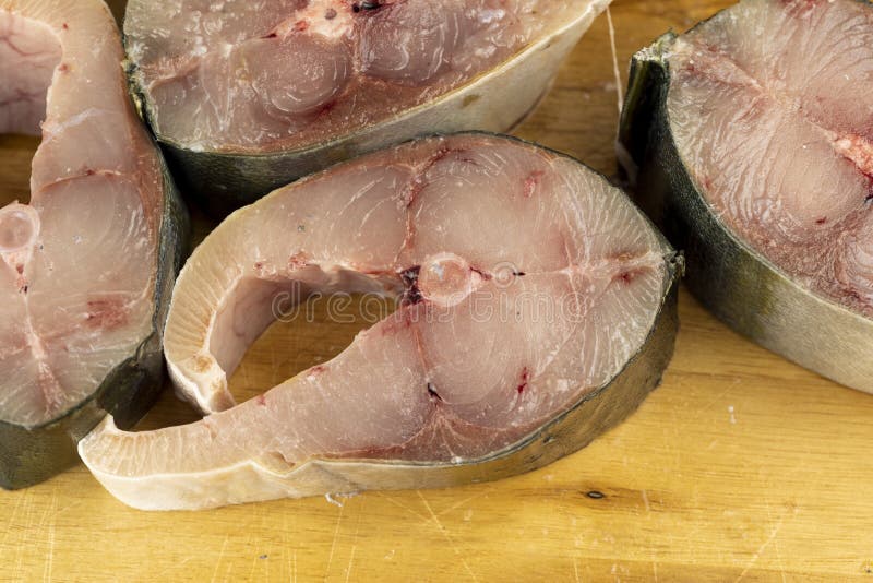 Raw Yellow-tailed Fish during Cutting for Cooking Stock Photo - Image ...