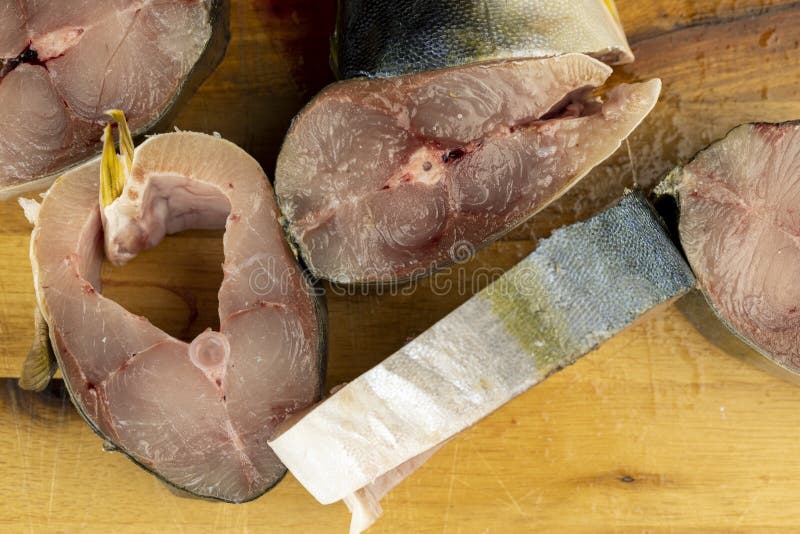 Raw Yellow-tailed Fish during Cutting for Cooking Stock Photo - Image ...