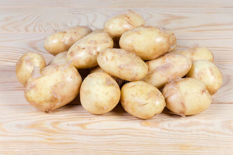 Raw Yellow Young Potatoes with Skin on the Rustic Table Stock Image ...
