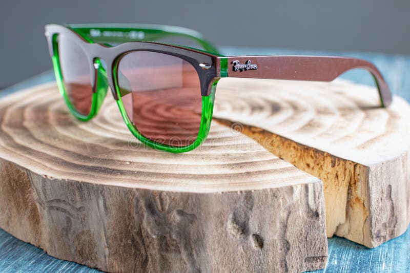 Ray-Ban Sunglasses with Green Frame on a Wooden Stump Editorial Image ...
