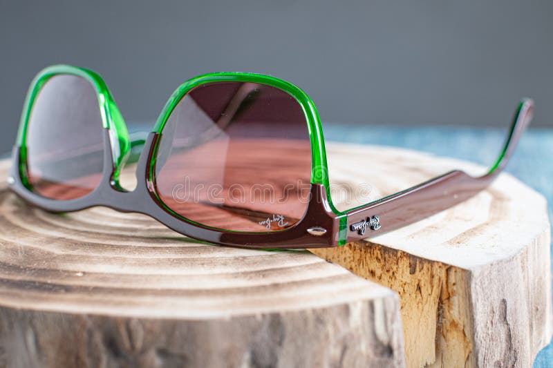 Ray-Ban Sunglasses with Green Frame on a Wooden Stump Editorial ...