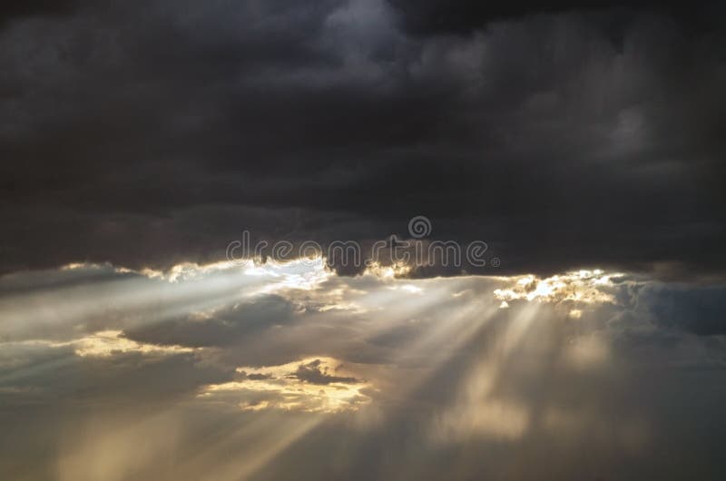 A Ray of Light through the Clouds. Rays of Light Breaking through Dark ...
