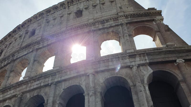 A Ray of Sun Passes through the Arches of the Colosseum in Rome, Italy ...