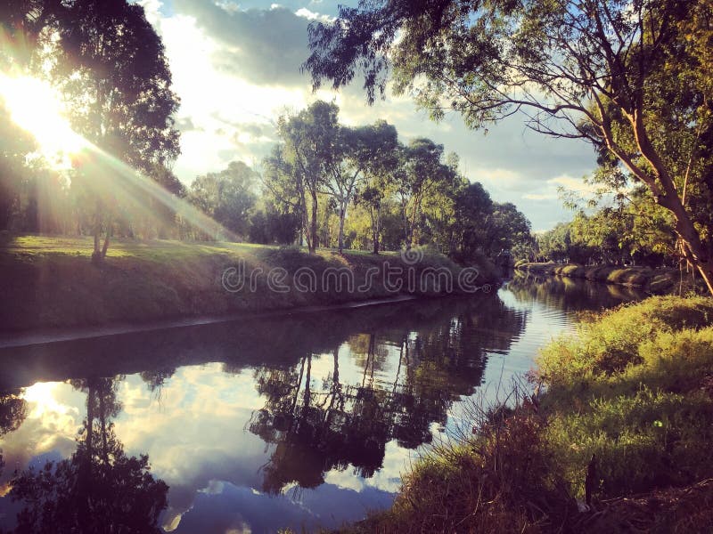 Ray of Sun and Reflection of Trees in River Stock Photo - Image of ...