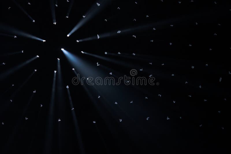 Rays of Bright Light Come through Holes in the Black Background of the ...