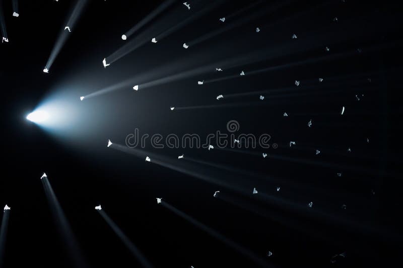 Rays of Bright Light Come through Holes in the Black Background of the ...