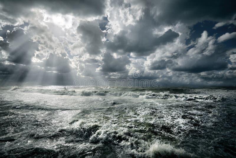 Rays of Light Filtering through the Clouds on Rough Winter Sea. Stock ...