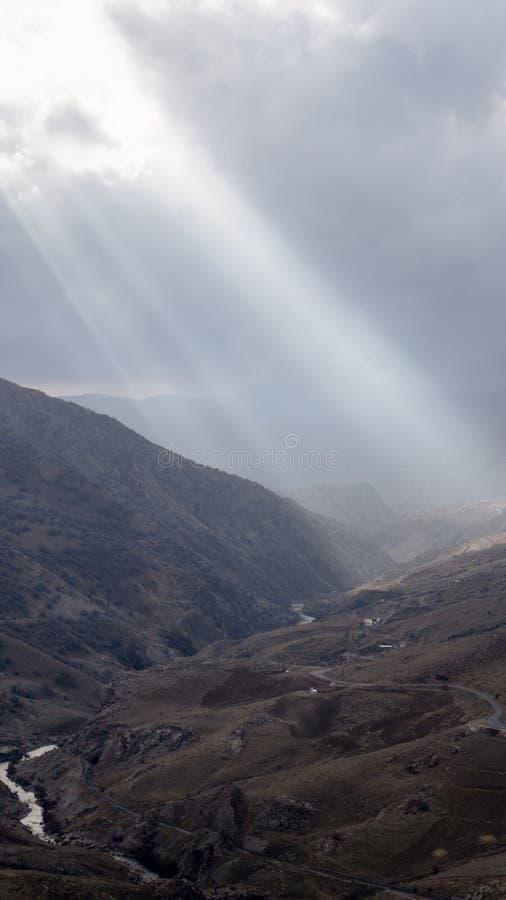 Sun Rays Passing through the Clouds Over the Valley Stock Image - Image ...