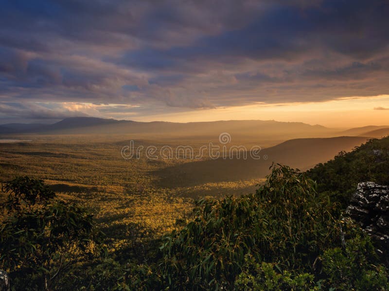 Rays of Light from Setting Sun Over Mountain Valley Stock Photo - Image ...