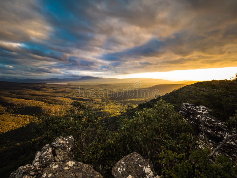 Rays of Light from Setting Sun Over Mountain Valley Stock Photo - Image ...