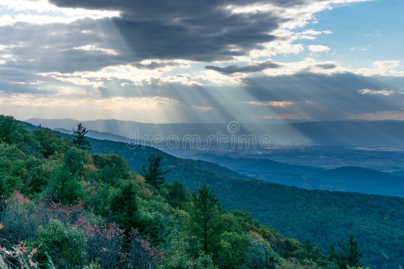 Rays of Light Shine through Clouds Over Blue Ridge Mountains Stock ...