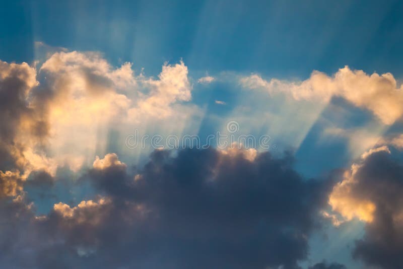 Rays of Light Shining through the Clouds in the Blue Sky Stock Photo ...