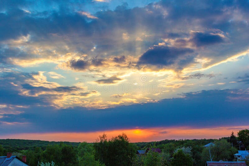 The Rays of the Sun Break through the Clouds on a Spring Evening ...