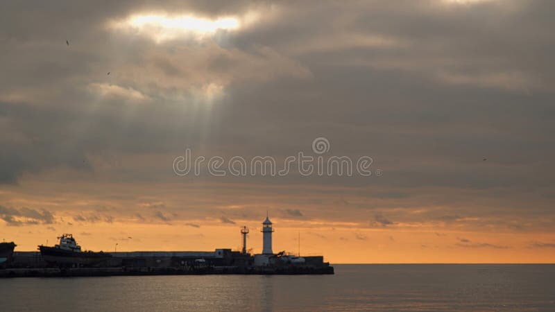 The Rays of the Sun through the Clouds Above the Pier with the ...