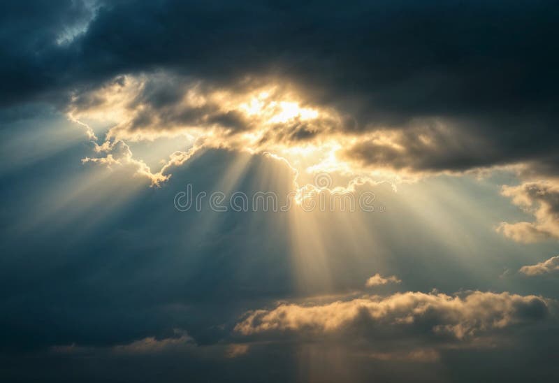 Rays of Sunlight Break through Dark Clouds during a Dramatic Sunset ...