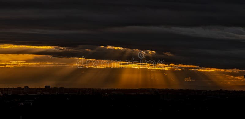 Rays of Sunlight through Heavy Dark Clouds Stock Photo - Image of ...