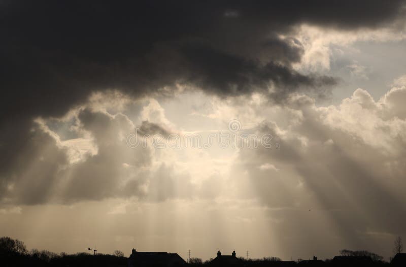 Rays of Sunlight Over Village Rooftop Silhouettes Stock Image - Image ...