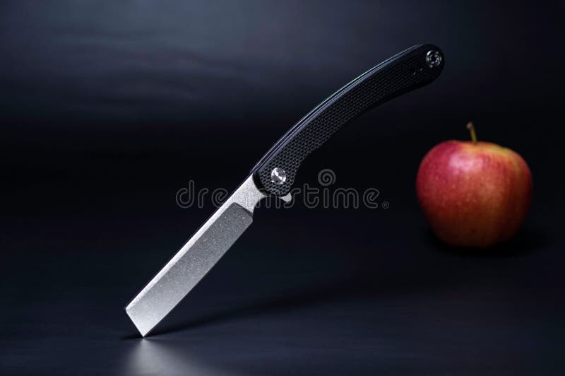Razor Knife and Apple. Razor and Apple on a Black Background Stock ...