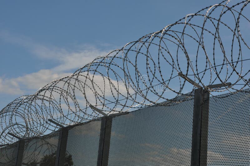 Razor wire with fence stock photo. Image of metal, blue - 26423566