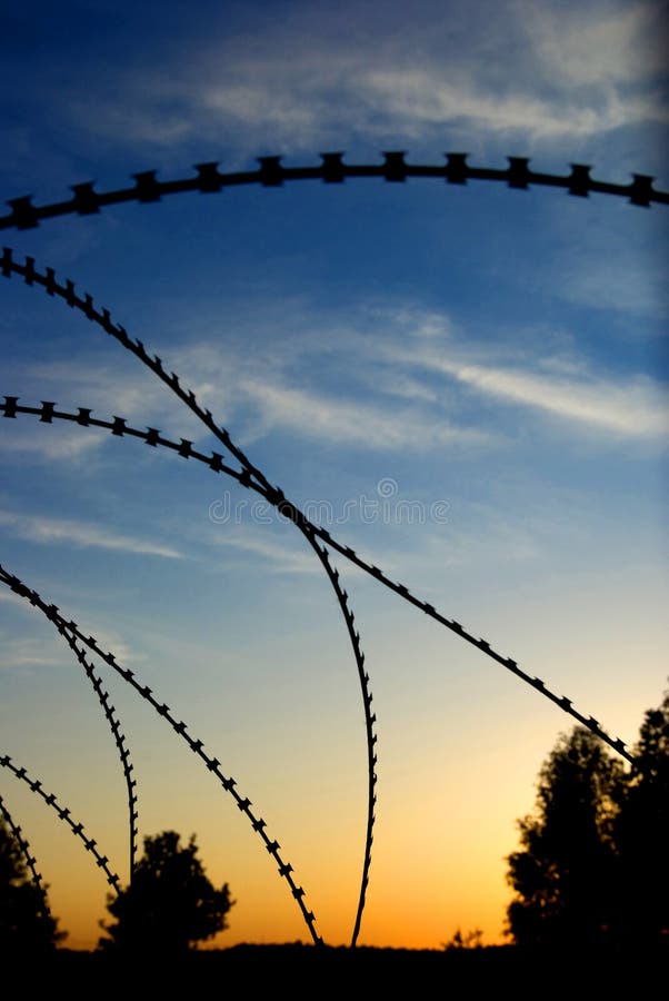Razor wire at sunset stock photo. Image of strand, silhouette - 2518760