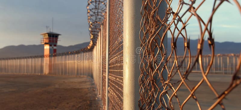 A Razor Wire Topped Chain Link Fence Surrounds a Prison Complex at ...