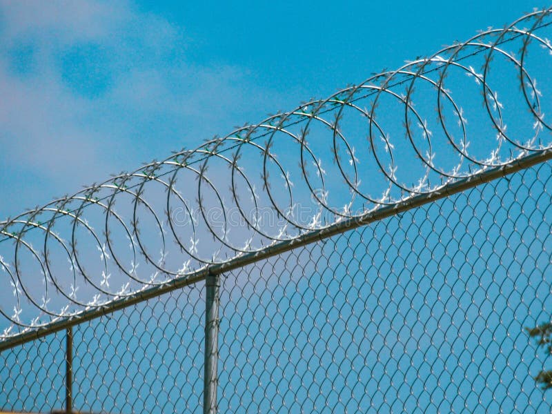 Razorwire Fence Atop a Chain Link Fence Stock Image - Image of district ...