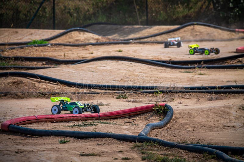 Yellow Electric RC Buggy Racing on an Offroad Track Stock Photo - Image ...