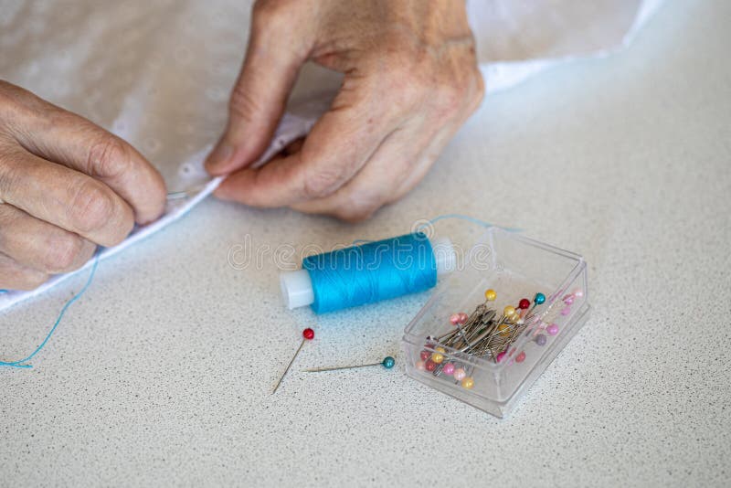 Re-stitching Old Things. Elderly Female Hands in the Process of Sewing ...