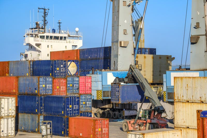 Reach Stacker Carry Container Along Bulk Carrier in Cargo Port on Sunny ...