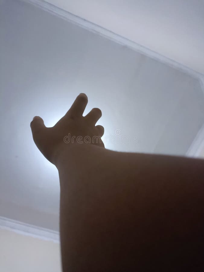 Reaching for the Light with Hands in a White Room? Stock Photo - Image ...