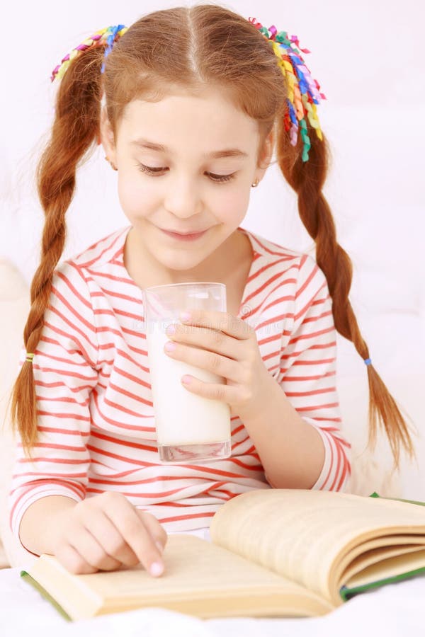 Read-haired Girl Drinking Milk and Reading Stock Photo - Image of ...