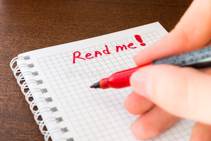 Read Me Sign in the Notebook by Red Marker in the Hand Stock Image ...