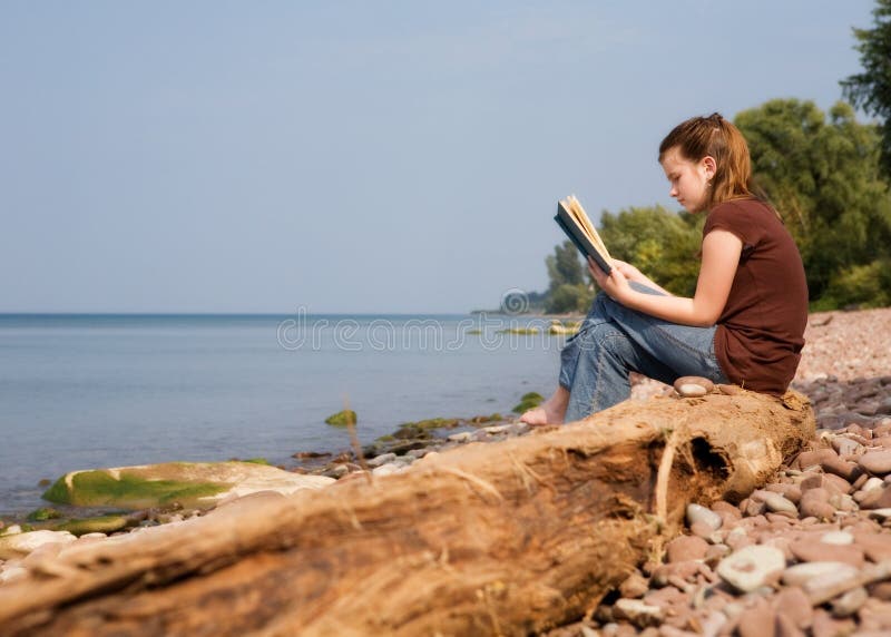 Reading at the beach stock image. Image of child, blue - 3217553