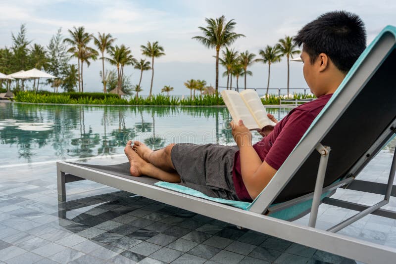 Reading Book at Beautiful Swimming Pool by the Beach Stock Photo ...