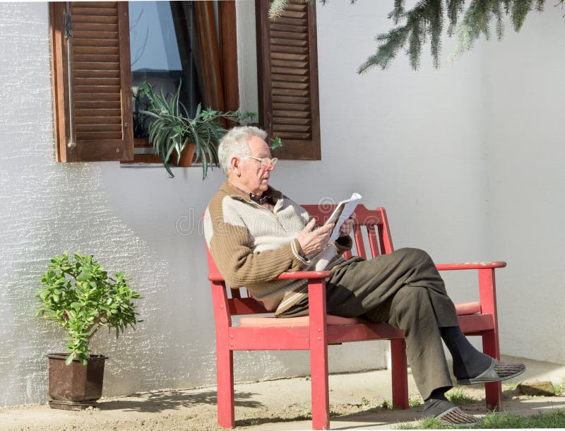 Reading book in courtyard stock image. Image of elderly - 37967869