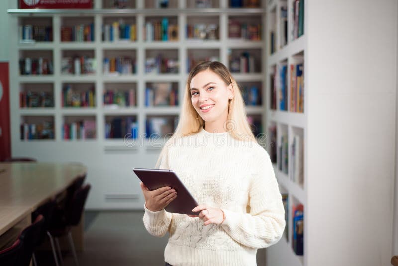 Reading Book in Library. Student in the Library with a Book in Her ...
