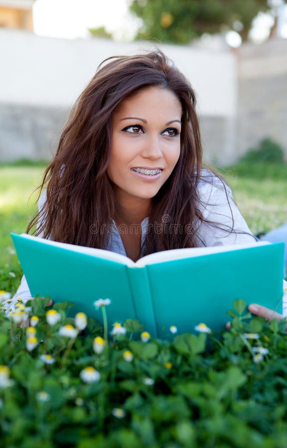 Reading a Book Lying on the Grass Stock Photo - Image of caucasian ...