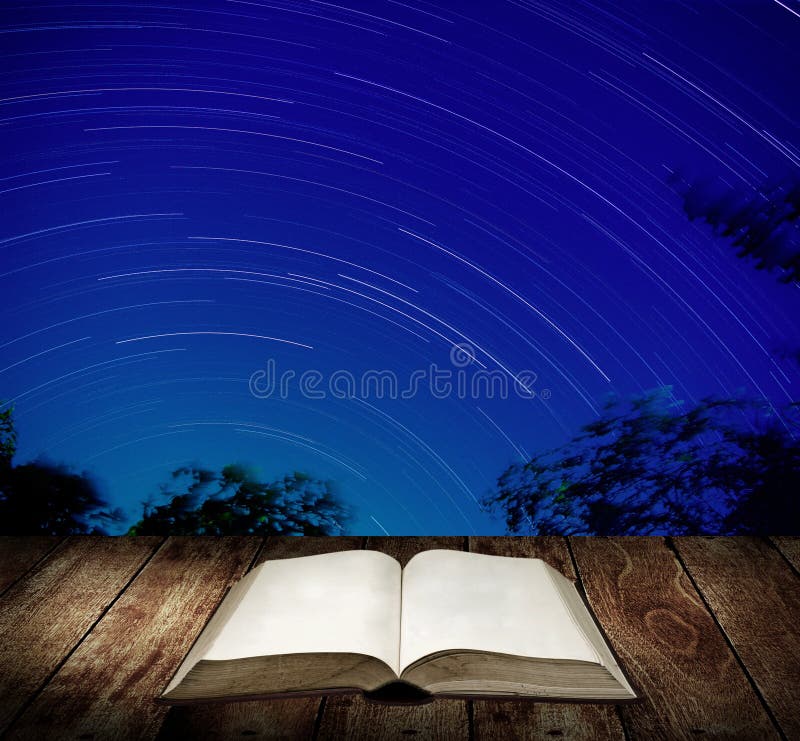 Reading Book With Star Trails Background Stock Photo - Image of ...