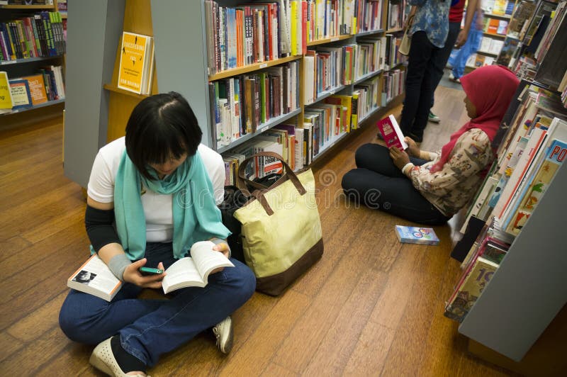 Reading at Book Store editorial stock image. Image of bookcase - 35260464