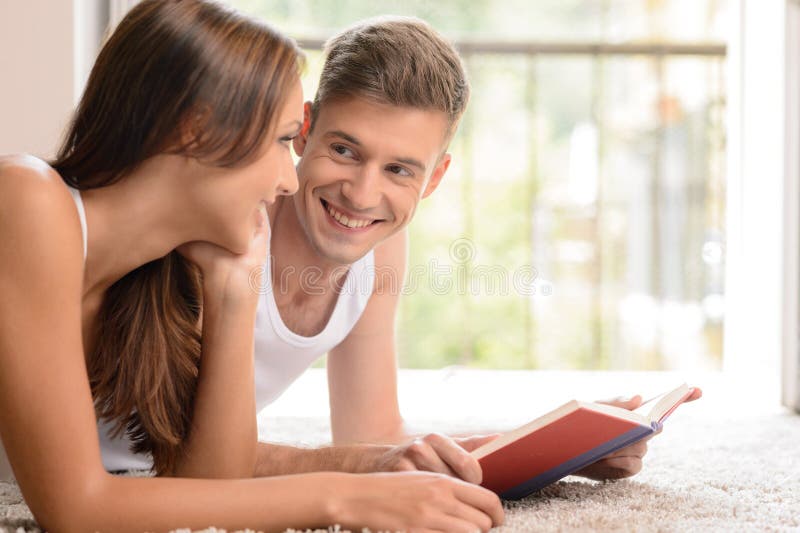 Reading A Book Together Handsome Young Men Reading A Book To Hi Stock