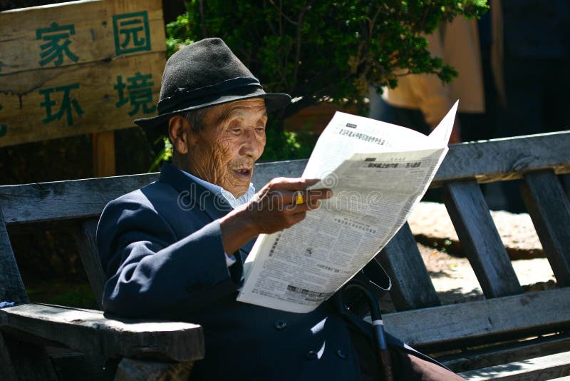 Reading Chinese newspaper editorial stock image. Image of read - 18583894