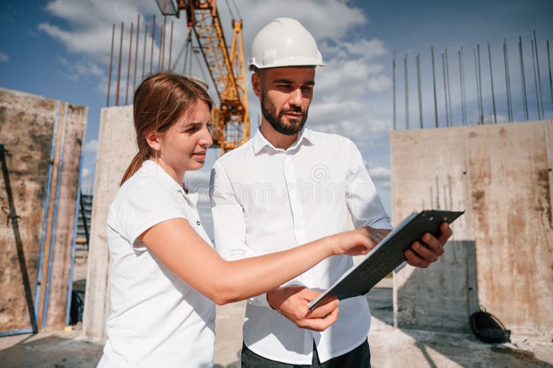 Reading the Document in Notepad. Man in Uniform Working with Woman on ...