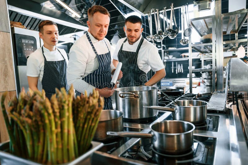 Reading the Documents. Kitchen Workers is Together Preparing the Food ...