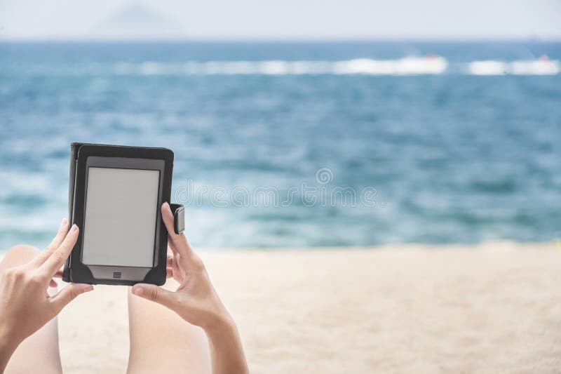 Reading from E-reader on the Beach Stock Photo - Image of boats ...