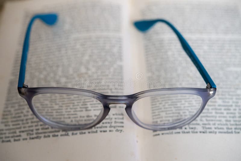 Light Blue Reading Glasses on a Book Stock Image - Image of open ...