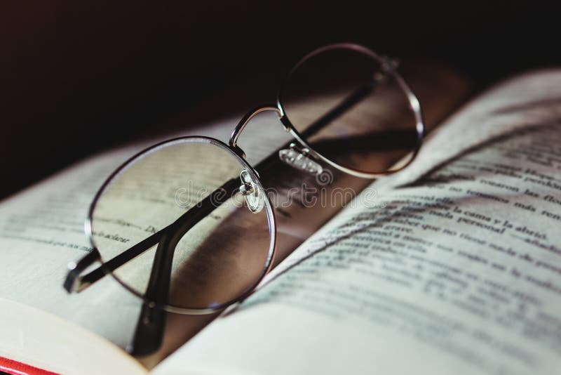 Reading Glasses on Top of an Open Book. Reading Glasses Stock Image ...